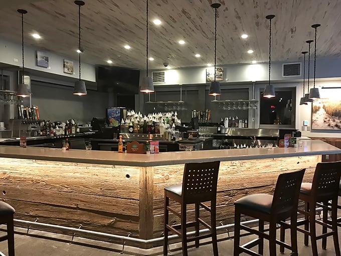 This bar doesn't just serve drinks—it serves moments. The illuminated wood front glows with promises of vacation stories.