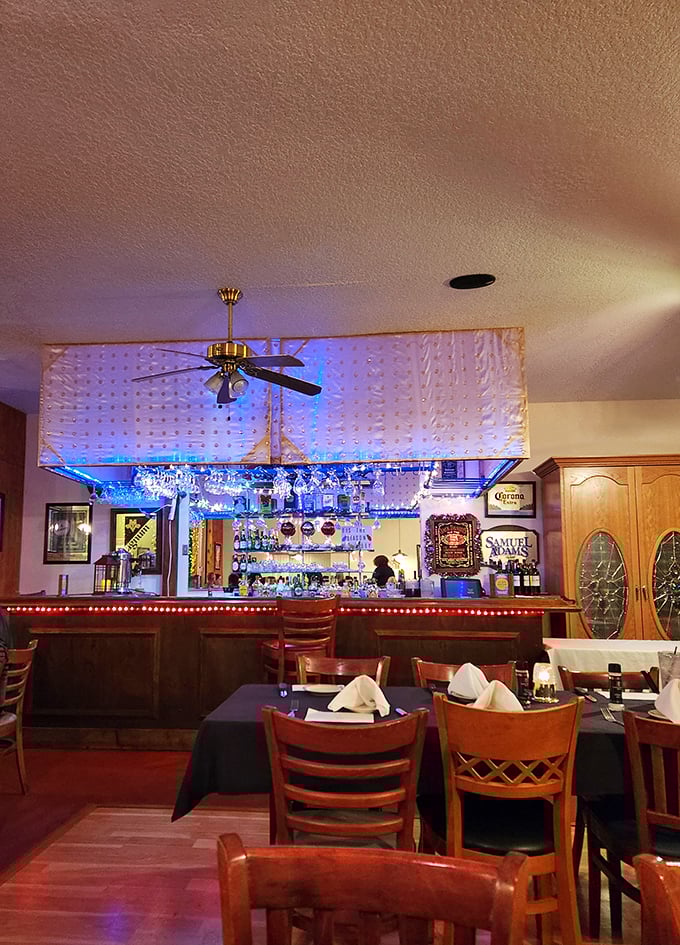 The bar area glows with blue light and possibility. Where stories are shared and friendships forged over perfectly mixed drinks.