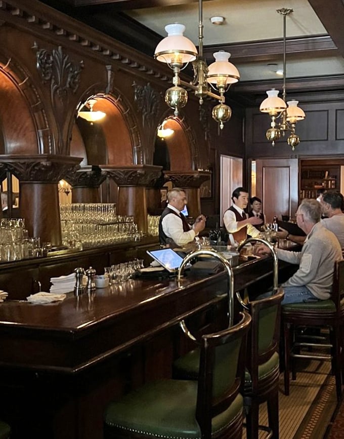 The bar isn't just where drinks are made; it's where stories begin – polished wood, attentive bartenders, and the promise of perfectly executed classics.