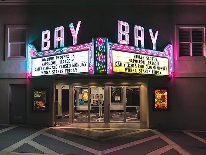 The Bay Theater's neon sign glows with vintage charm, promising entertainment the old-fashioned way in this thoroughly modern world.