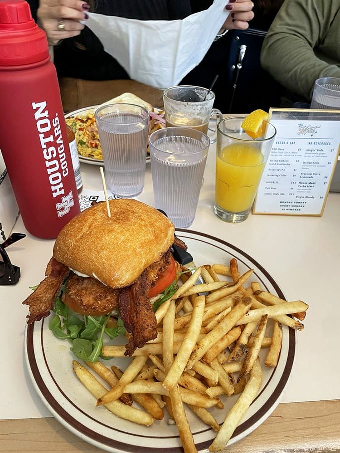 The Belmont chicken sandwich with fries: proof that lunch at a breakfast joint isn't settling—it's strategic brilliance.