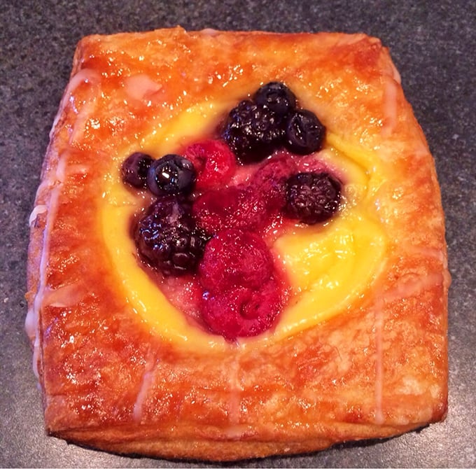 A Danish that transforms breakfast from necessity to luxury—butter-laminated dough cradling summer berries like precious gems.