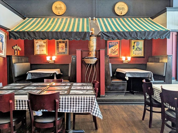 These cozy booths with their green-and-white striped awnings create little neighborhoods within the restaurant – perfect for intimate conversations or passionate pizza debates.