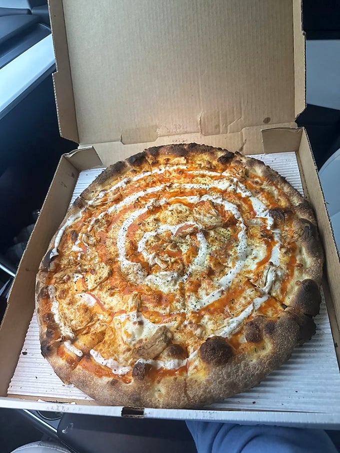 A buffalo chicken pizza with sauce swirled like modern art. Van Gogh would've traded a sunflower painting for just one slice of this masterpiece.