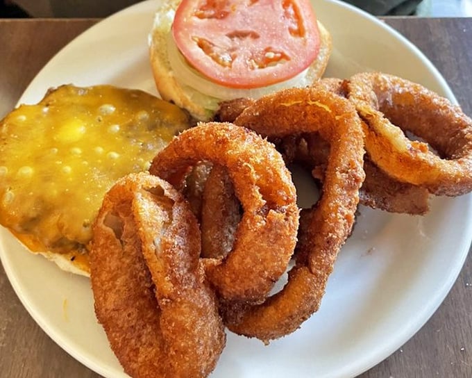 Golden onion rings that shatter with each bite alongside a burger that's been perfected over decades – simplicity at its most delicious.
