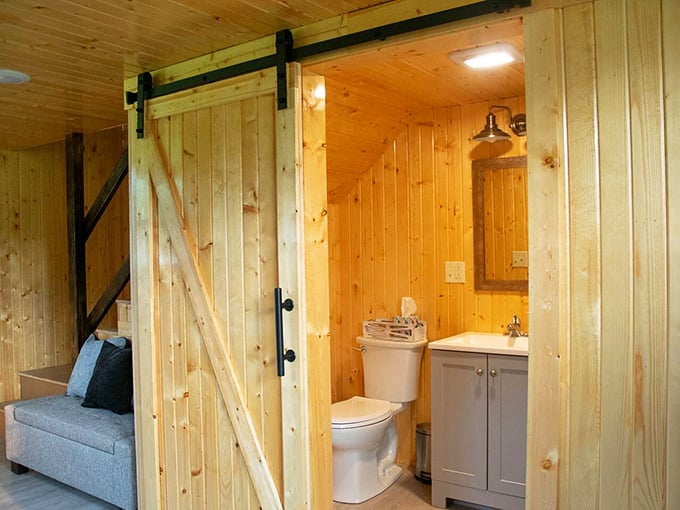 Barn door brilliance in the bathroom. Sliding wood doors add architectural interest while saving space in this thoughtfully designed modern country bathroom.