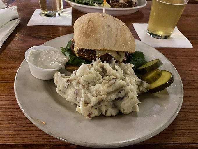 A burger served with proper mashed potatoes instead of fries – the kind of culinary audacity that deserves our respect and devotion.