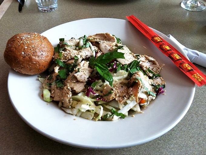 A salad that makes you forget you're eating healthy—tender chicken, crisp vegetables, and herbs in perfect harmony with a rustic roll.