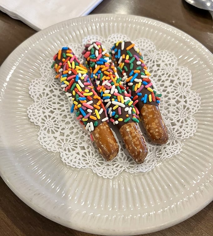 Chocolate-dipped pretzels with rainbow sprinkles – because sometimes breakfast deserves a little party on a doily.