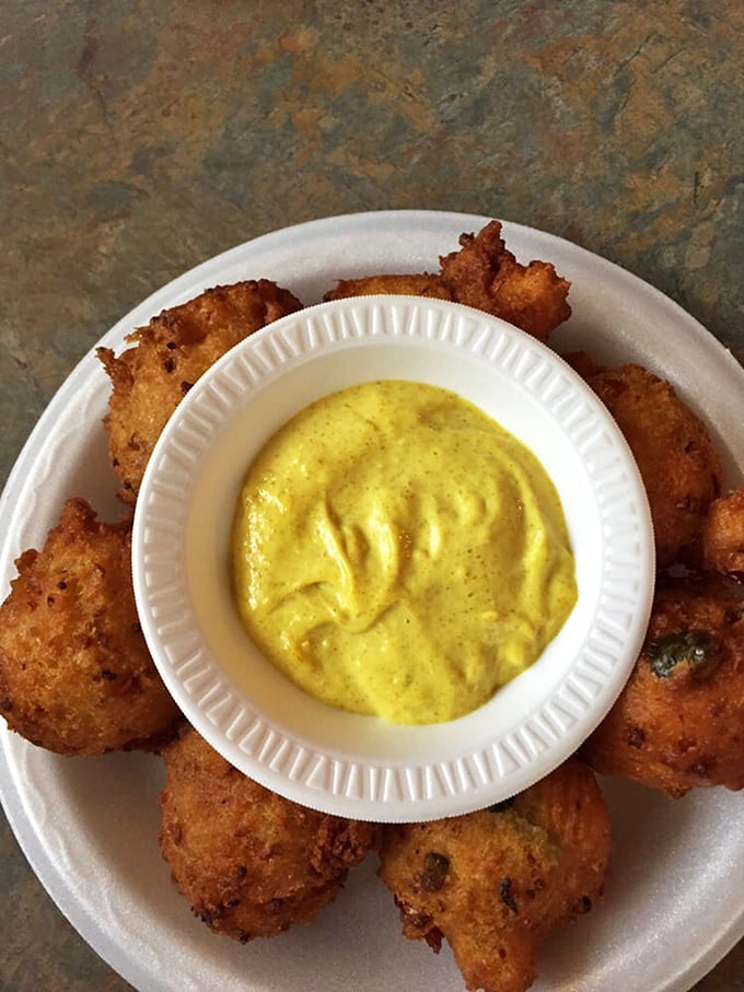 These golden fritters surround a creamy dipping sauce like planets orbiting a delicious sun—one bite and you'll understand why they're legendary.