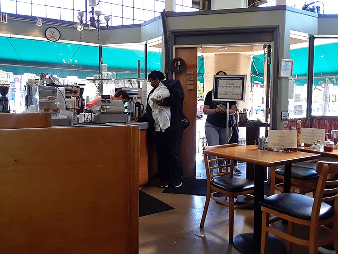 The counter seating—where solo diners find community and regulars exchange knowing nods about which specials are worth the caloric splurge.
