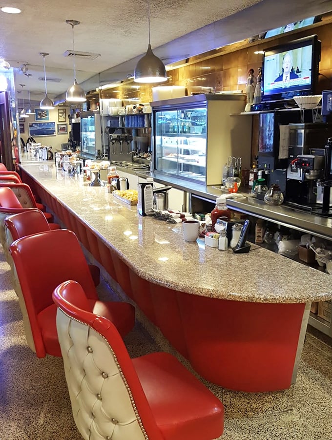 The counter seating—where solo diners become temporary members of the most delicious club in town, with front-row views of short-order magic.