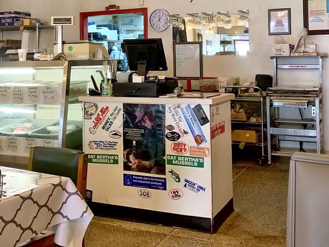 Where the magic begins—a humble counter that serves as the gateway between hungry customers and seafood nirvana. The stickers tell stories of loyalty.