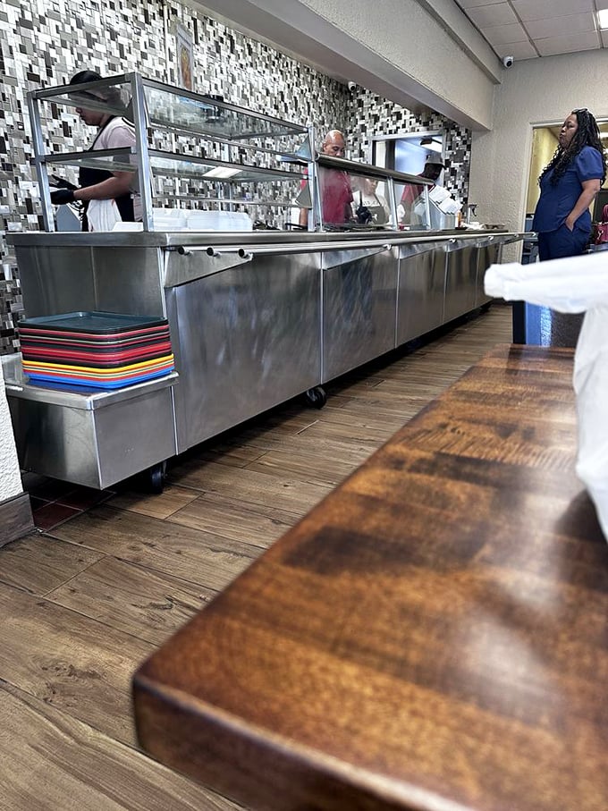 The serving line—where dreams come true and diets go to die. Those colorful trays stacked at the ready know they're about to witness culinary joy.