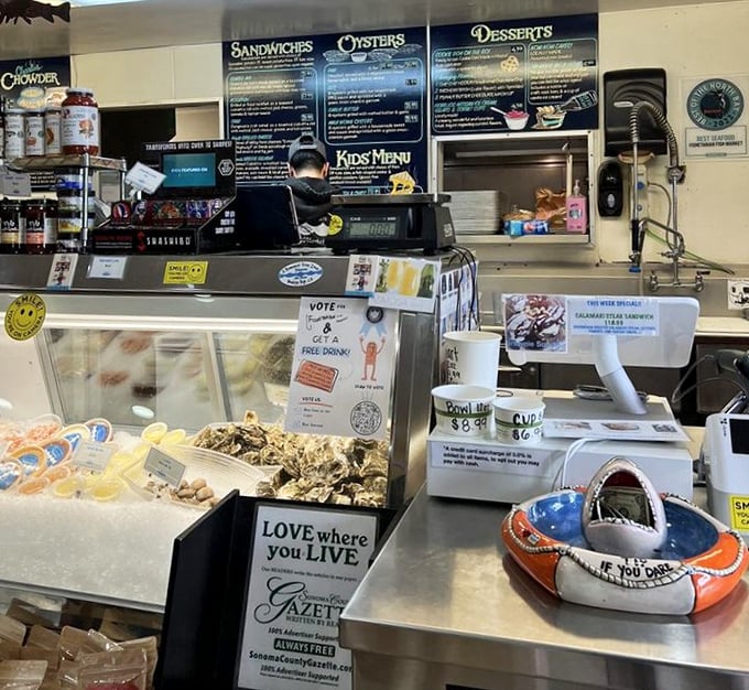 At the counter, where seafood magic happens – that little lifesaver ring is appropriate because these flavors might just save your soul.