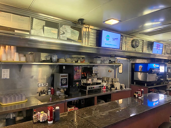 The counter—where solo diners find community, coffee cups are never empty, and the staff performs the ballet of diner service with practiced precision.