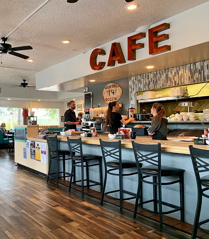 The counter where breakfast magic happens—complete with vintage "CAFE" sign and the promise of coffee refills as far as the eye can see.