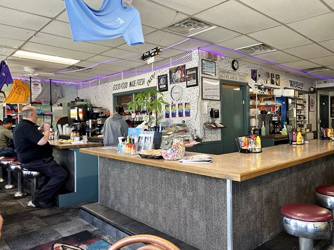 The counter—command central where coffee flows freely and regulars exchange news of the day while eyeing what's cooking on the grill.