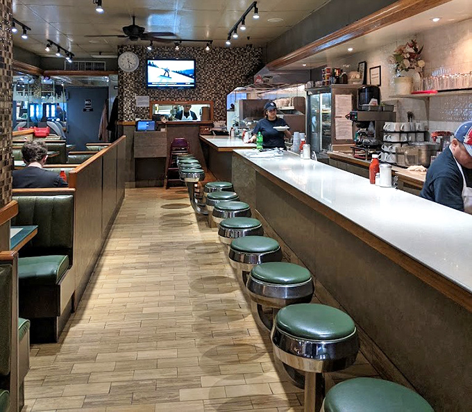 The counter seating—where solo diners become regulars and the short-order ballet unfolds before your eyes. Prime real estate for people-watching.