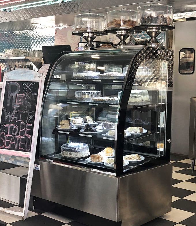 The dessert case—where willpower goes to die. Each pie and cake patiently waits its turn to ruin your diet plans.