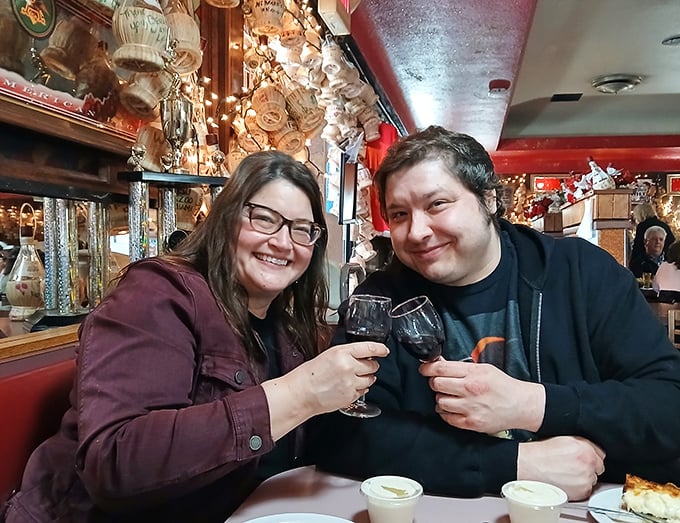 Happy diners toasting to the universal truth: great pizza creates great moments. Their expressions say what words can't—they've found pizza nirvana.