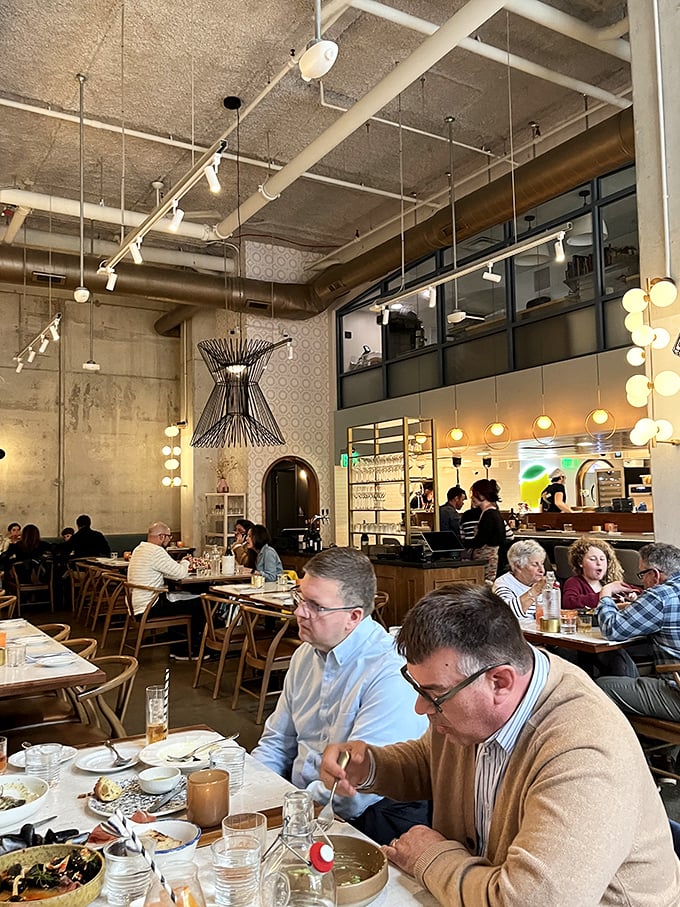 The dining room buzzes with the symphony of satisfaction—forks meeting plates, glasses clinking, and the universal sound of people having a genuinely good time.