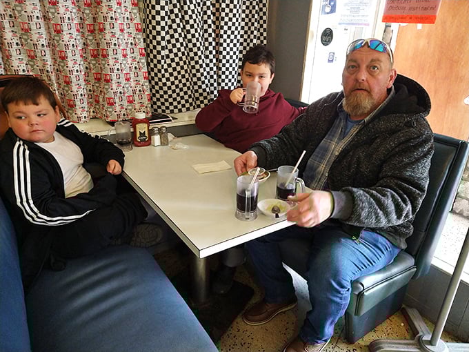 Three generations sharing sodas and stories—the true magic of places like Porky's isn't just on the plate, it's around the table.