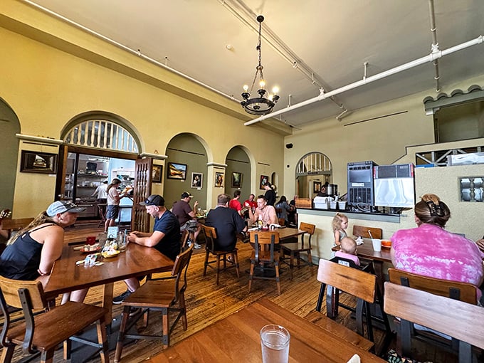 Multiple arched doorways and warm lighting create an atmosphere where everyone feels welcome, from families to solo diners with their morning newspaper.