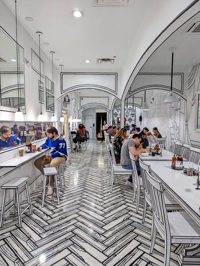 The restaurant buzzes with diners experiencing food and fantasy simultaneously. Notice how everyone's phones are out—this place is social media catnip.
