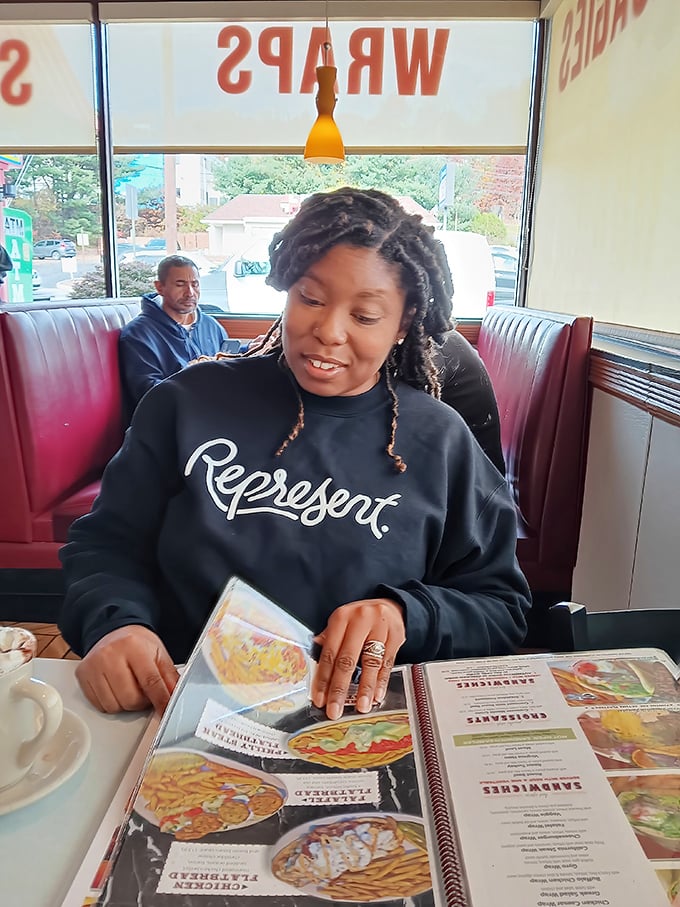 The red vinyl booths aren't just seating – they're front-row tickets to the greatest show on earth: watching other people's food arrive while you wait for yours.