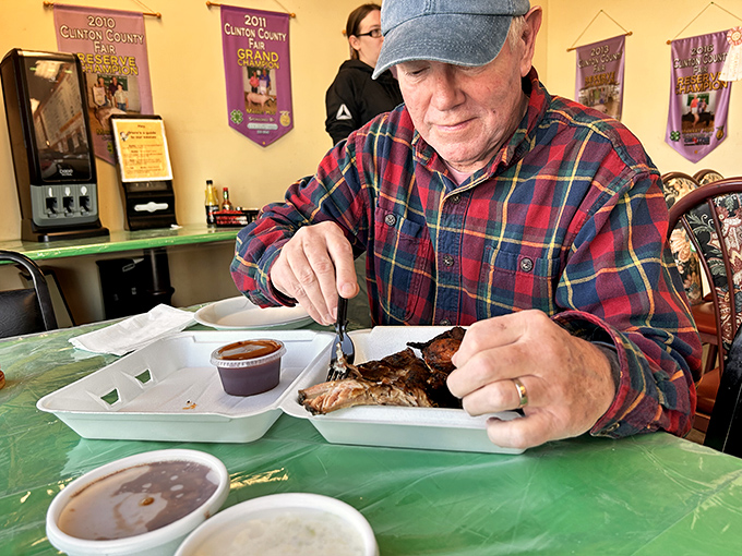 Every great BBQ joint has its devoted regulars. This gentleman knows the proper way to savor ribs—with focus and appreciation.