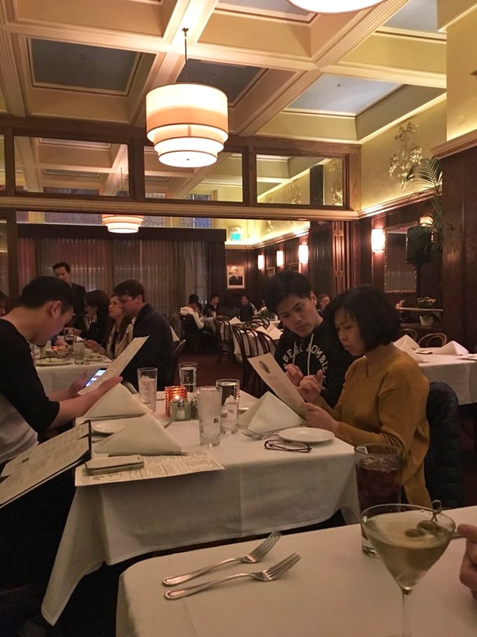 Diners lost in the ritual of great food and conversation – the true magic of John's Grill happens between bites.