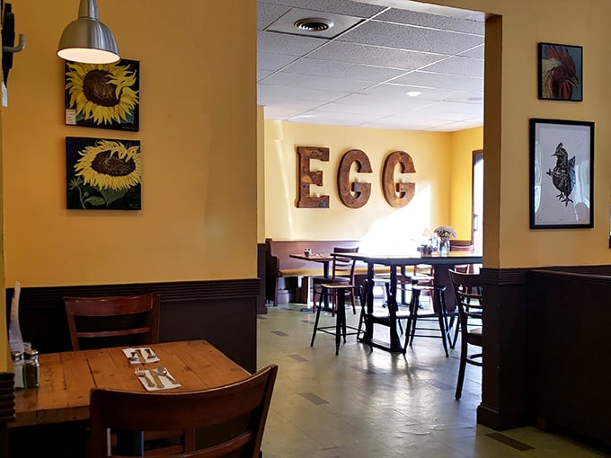 Sunflower art and rustic "EGG" letters announce exactly what this place worships—the humble breakfast staple elevated to art form.