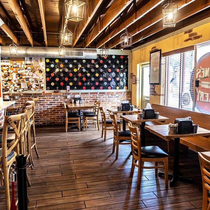 Exposed brick, wooden beams, and vinyl records on the wall—this isn't just decoration, it's a time machine disguised as a dining room.