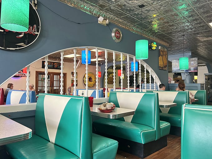 Mint green booths with retro white stripes – the kind of seating that invites you to slide in and stay until the coffee pot runs dry.
