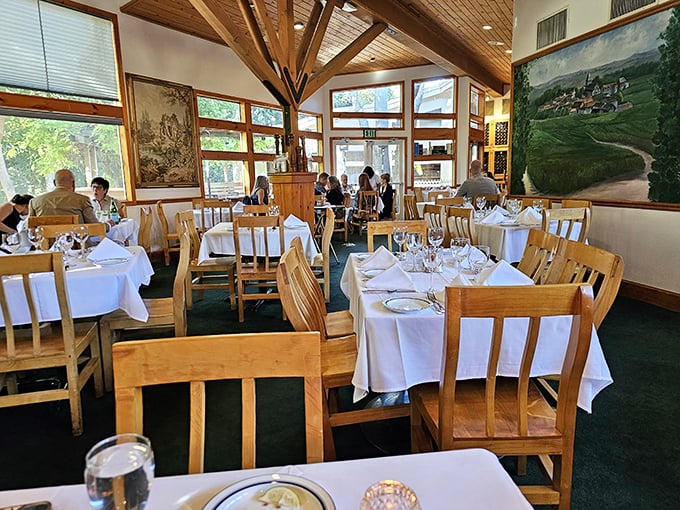 White tablecloths, wooden chairs, and sunlight streaming through windows—this dining room sets the stage for memories made between courses.