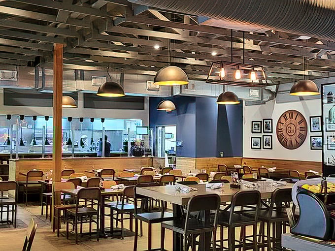 A dining room where industrial meets warmth – pendant lights casting a glow that makes everyone look like they're in a barbecue commercial.