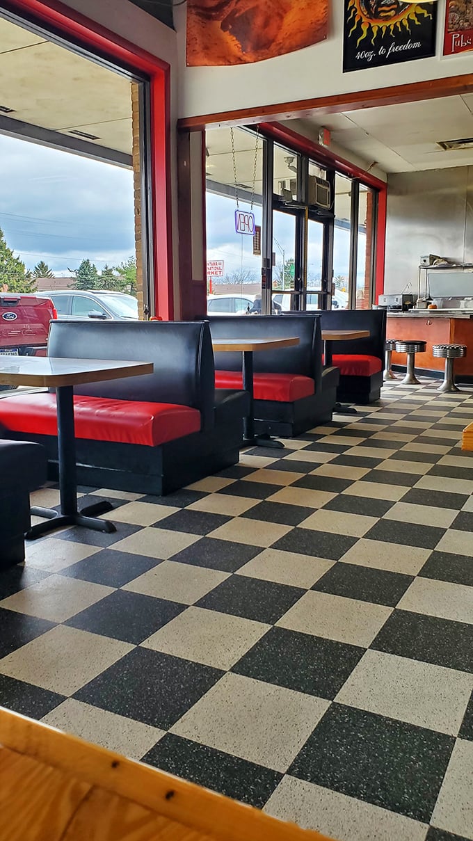 Red vinyl booths against checkered floors – the classic diner aesthetic that says "good food doesn't need fancy surroundings to be memorable."