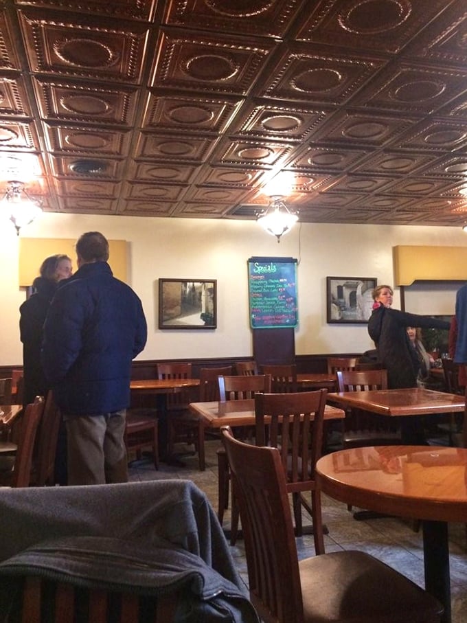 The dining room's ornate tin ceiling and warm lighting create that rare atmosphere where both first dates and family reunions feel equally at home.