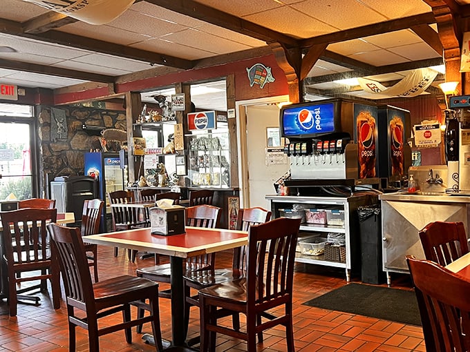 The dining room balances rustic charm with barbecue functionality – wooden chairs that have hosted countless happy diners and sauce-stained napkins.