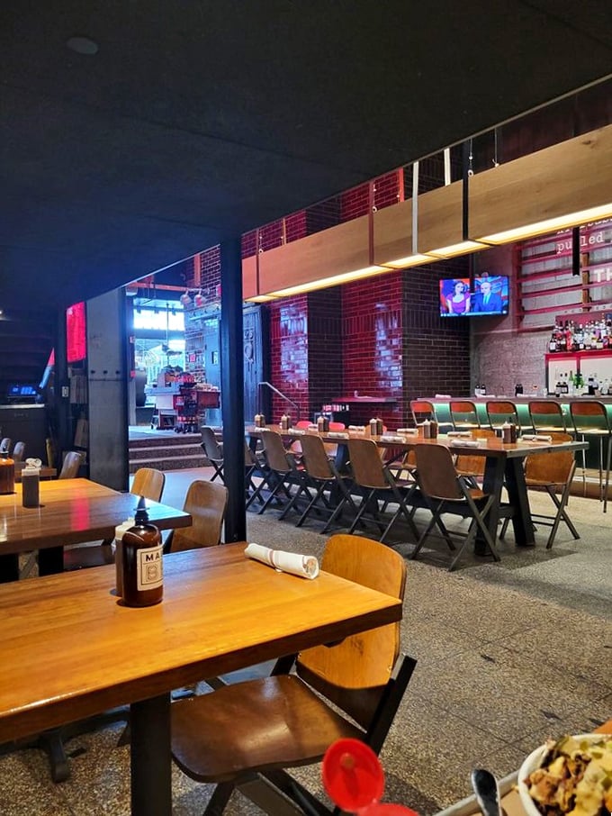 Modern meets traditional in a dining room where communal tables turn strangers into fellow meat enthusiasts.