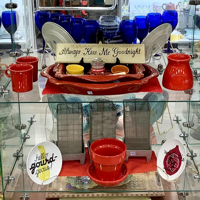 Cobalt blue glassware and cheery red pottery – someone's dining table is about to get a colorful upgrade. That "Kiss Me Goodnight" sign seals the deal.