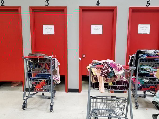 The fitting room area—where thrift store dreams either come true or die. Those carts hold the hopes, aspirations, and occasional reality checks of bargain seekers.