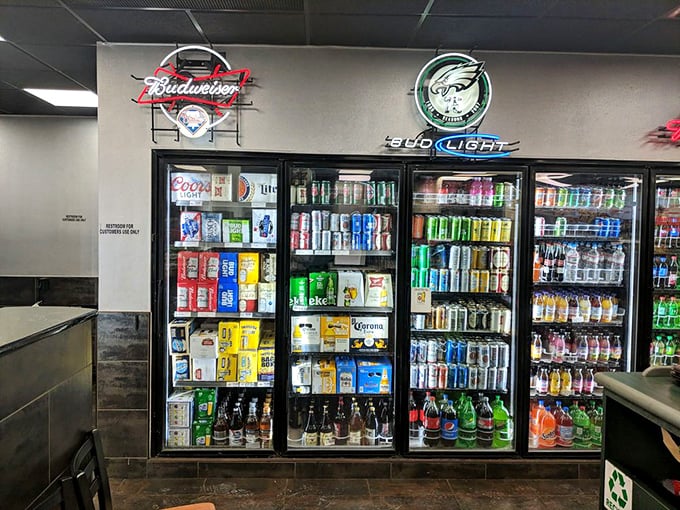 Philadelphia sports memorabilia watches over the drink coolers like guardian angels of hydration. Eagles, Phillies, and fizzy drinks – a perfect trio.