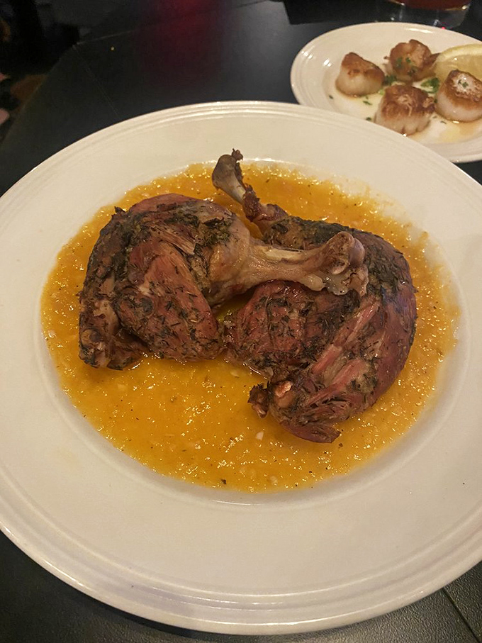 Duck confit swimming in a golden pool of sauce—proof that supper clubs can deliver rustic elegance that would make fancy city restaurants jealous.