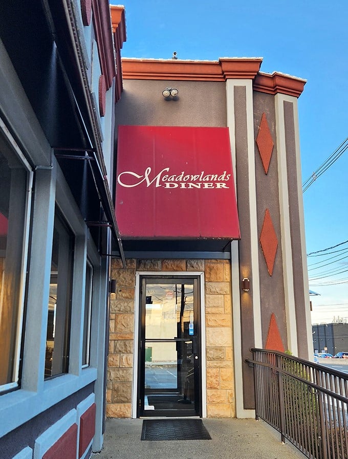 The entrance to Meadowlands Diner—where the red awning might as well say "Welcome Home" instead of the actual restaurant name.