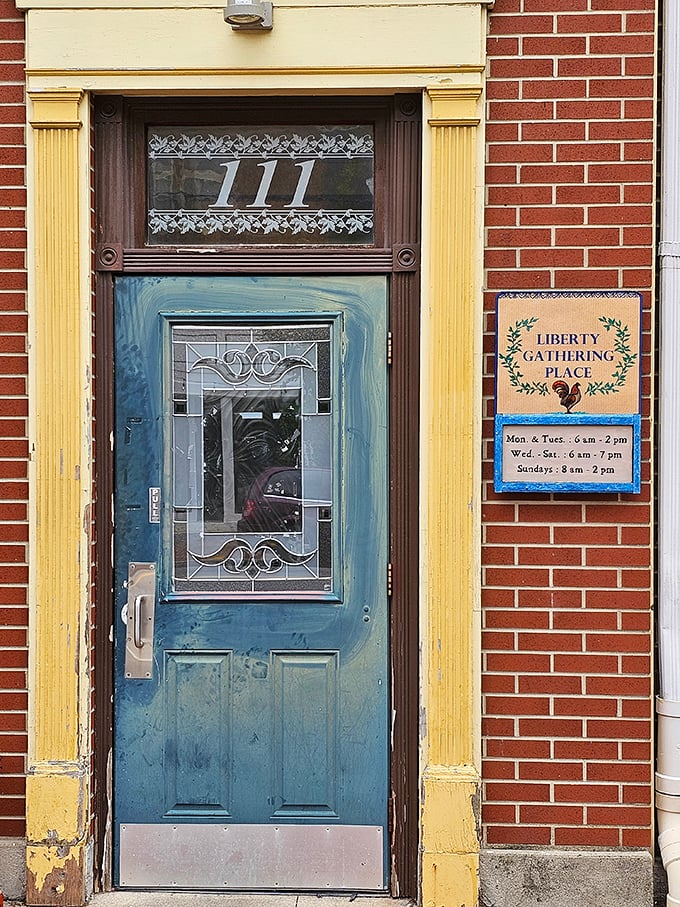 That blue door with its etched glass and the address "111" isn't just an entrance—it's a portal to the heart of West Liberty.