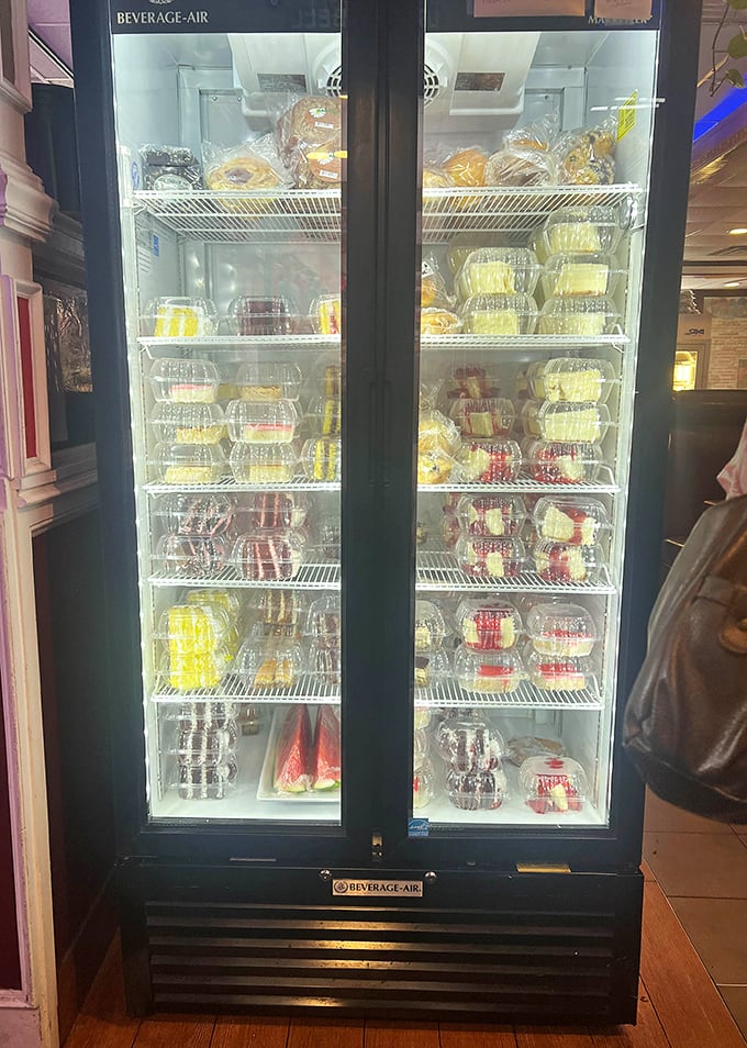 The dessert case—a glass-fronted temple of temptation where willpower goes to die and happiness begins.