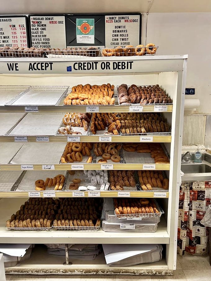 Shelf after shelf of donut varieties—like a library where every book is a bestseller and you're encouraged to devour them all.
