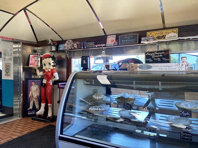 The dessert case – where willpower goes to die a delicious death. Each pie is practically winking at you, daring you to say "just coffee."